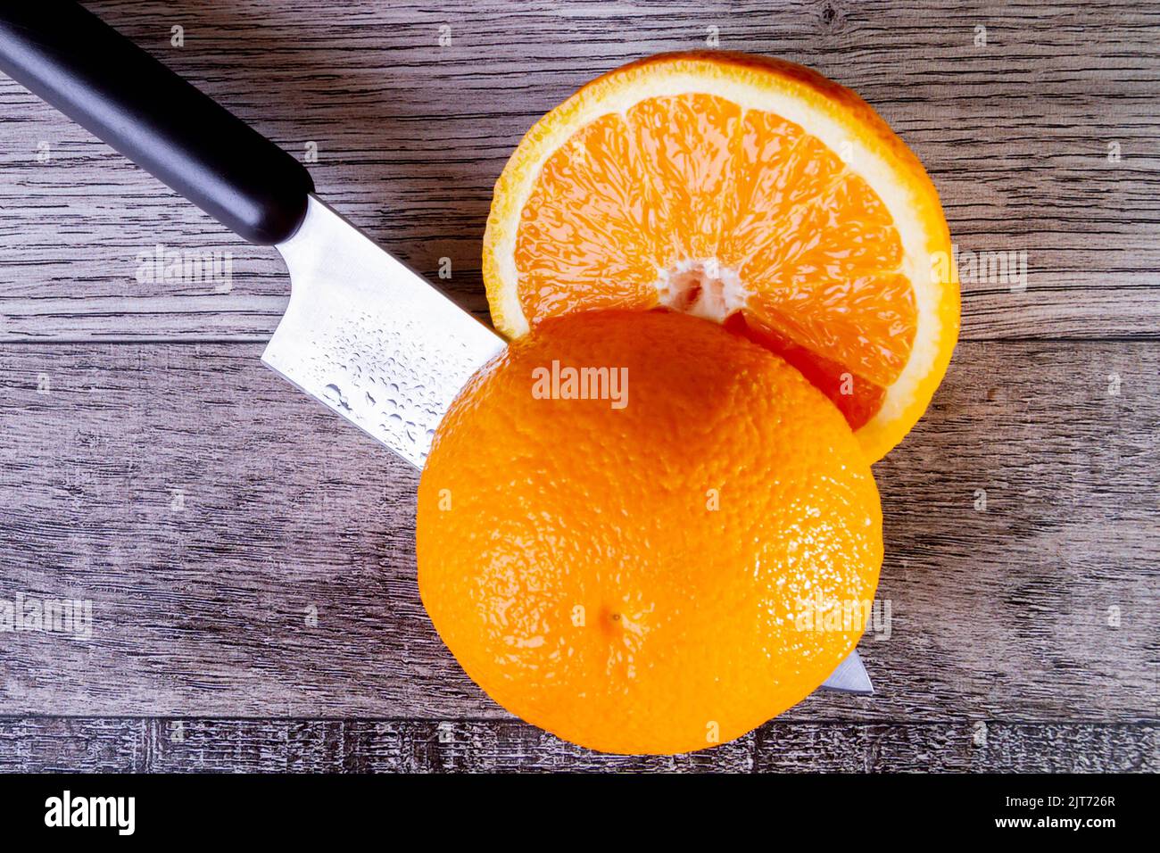 Vue de dessus de la tranche d'oranges. Il y a un couteau et des ...