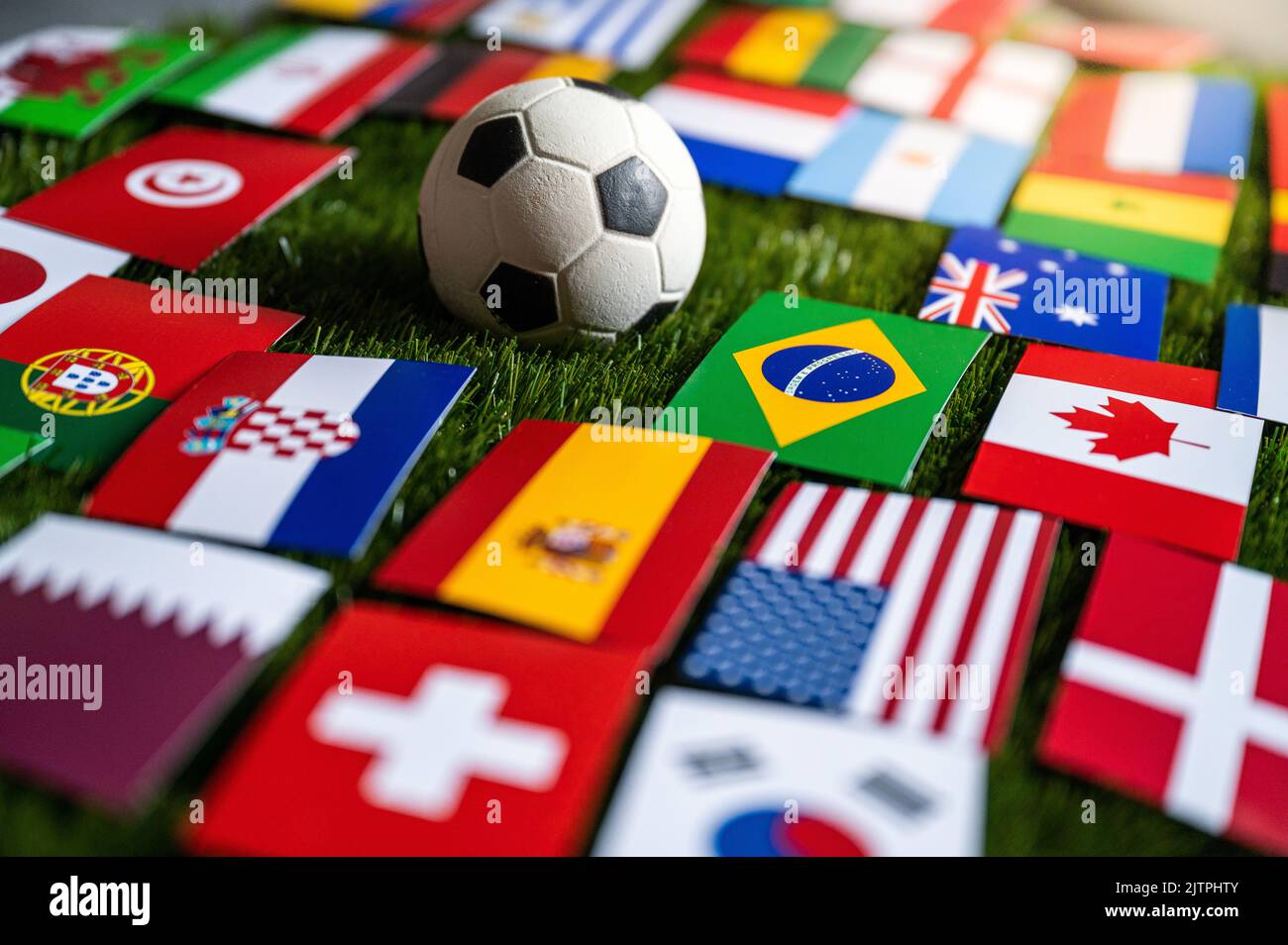 Football ball et drapeaux des 32 pays qui joueront au Qatar. Papier ...