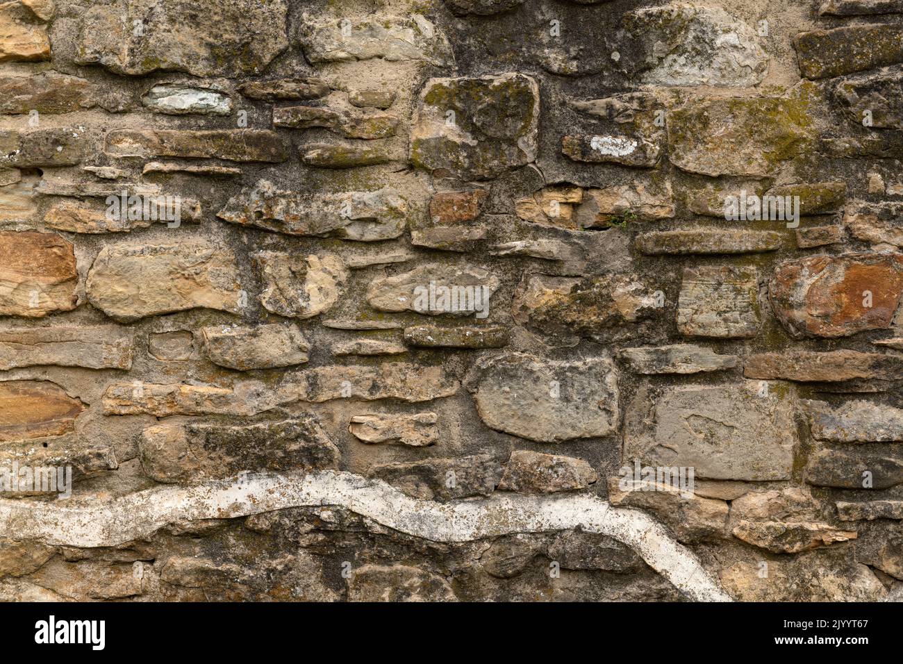 Gros plan de l'ancien mur en pierre avec un coulis épais et une surface ...