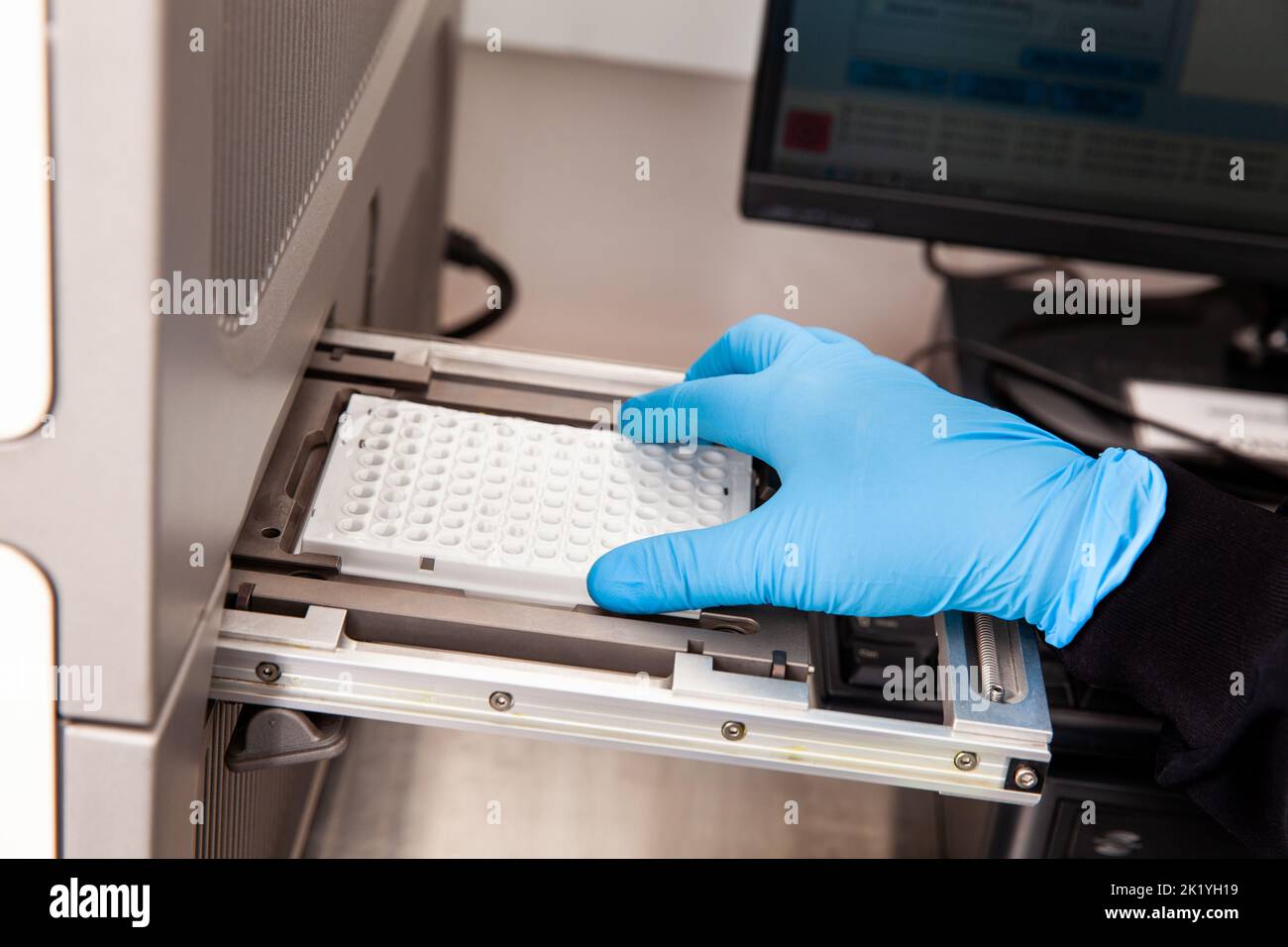Un scientifique charge des échantillons dans un thermocycleur RT-PCR au ...