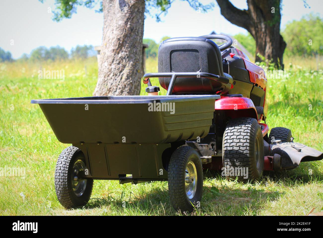 Tondeuse tracteur avec attelage et remorque dans un jardin Photo Stock ...