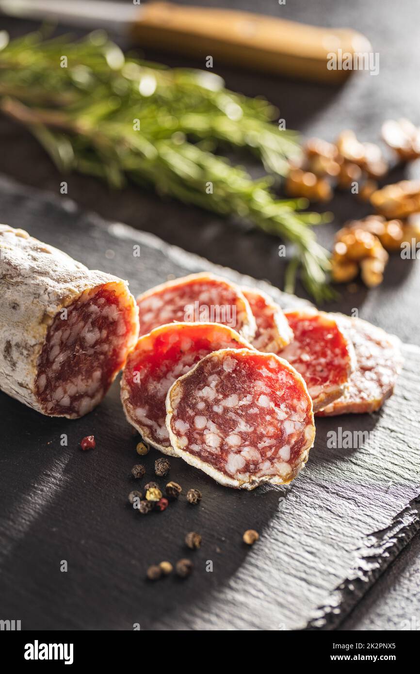 Saucisse traditionnelle avec moule blanc. Salami de porc en tranches séchées sur la planche à ...