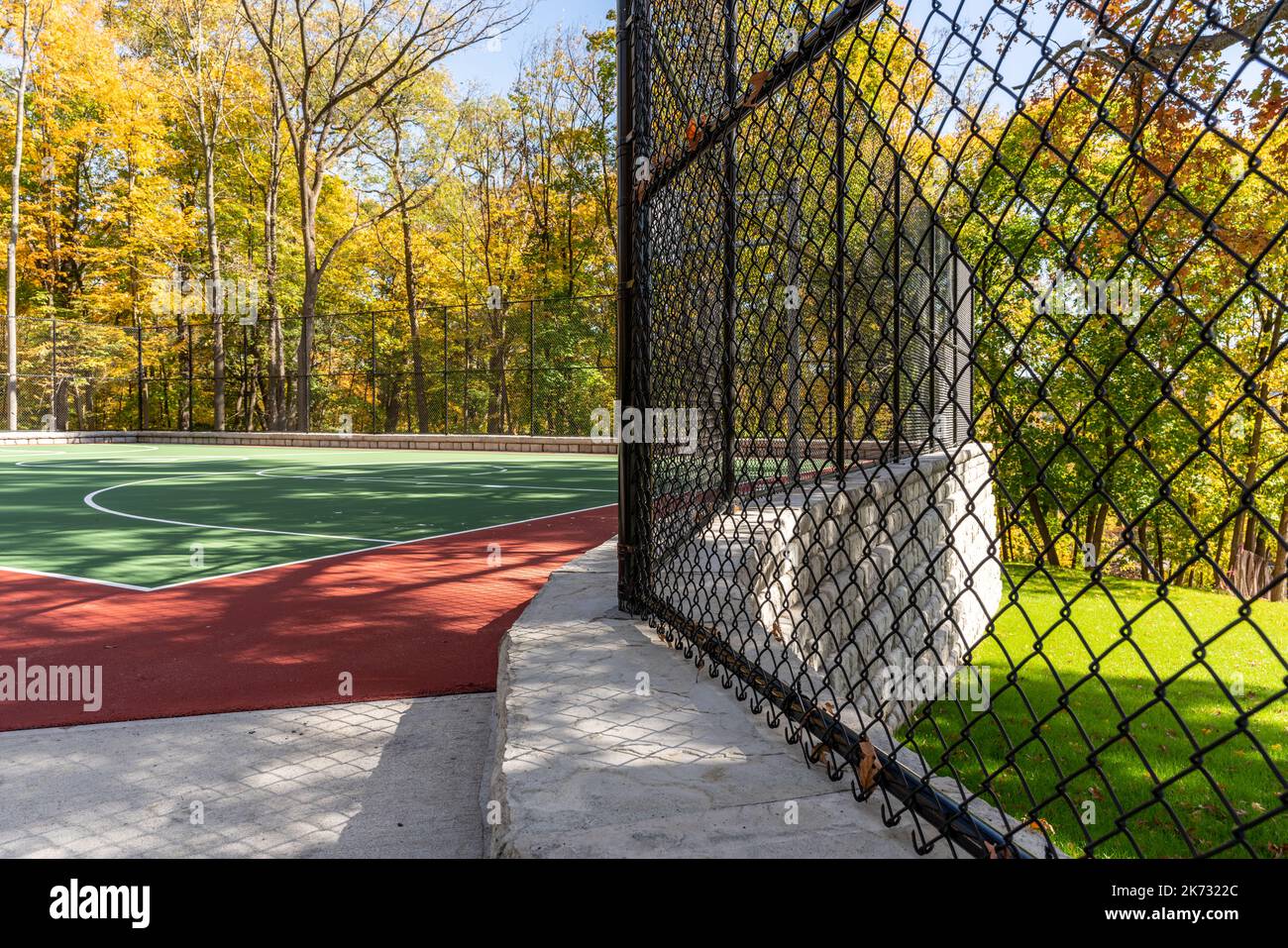trottoir en béton avec mur de soutènement et terrain de basket-ball ...