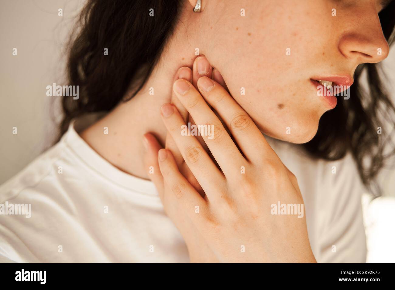 Malade belle fille touche la gorge avec la douleur. Pharyngite premiers ...