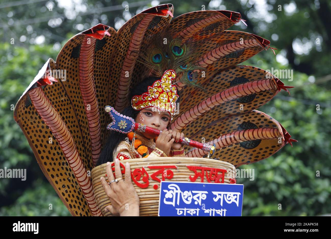 Un couple pose comme Sri Krishna et Radha sur un paon comme flotteur dans une procession ...