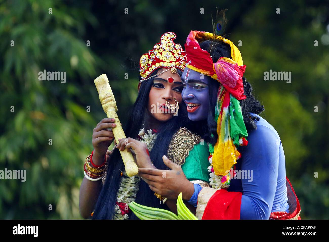 Un couple pose comme Sri Krishna et Radha sur un paon comme flotteur dans une procession ...