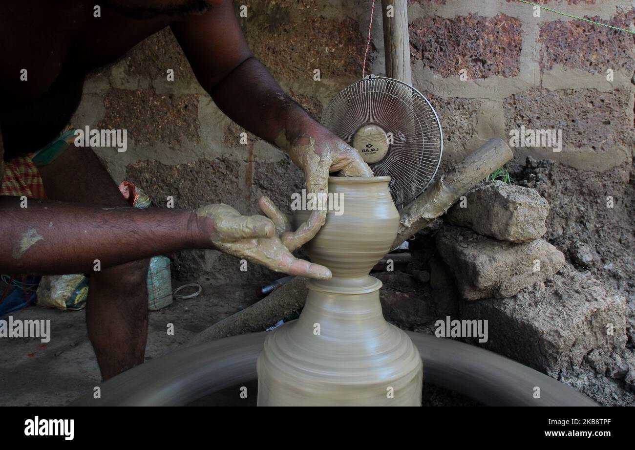 Les potiers traditionnels sont occupés à fabriquer des pots de terre et ...