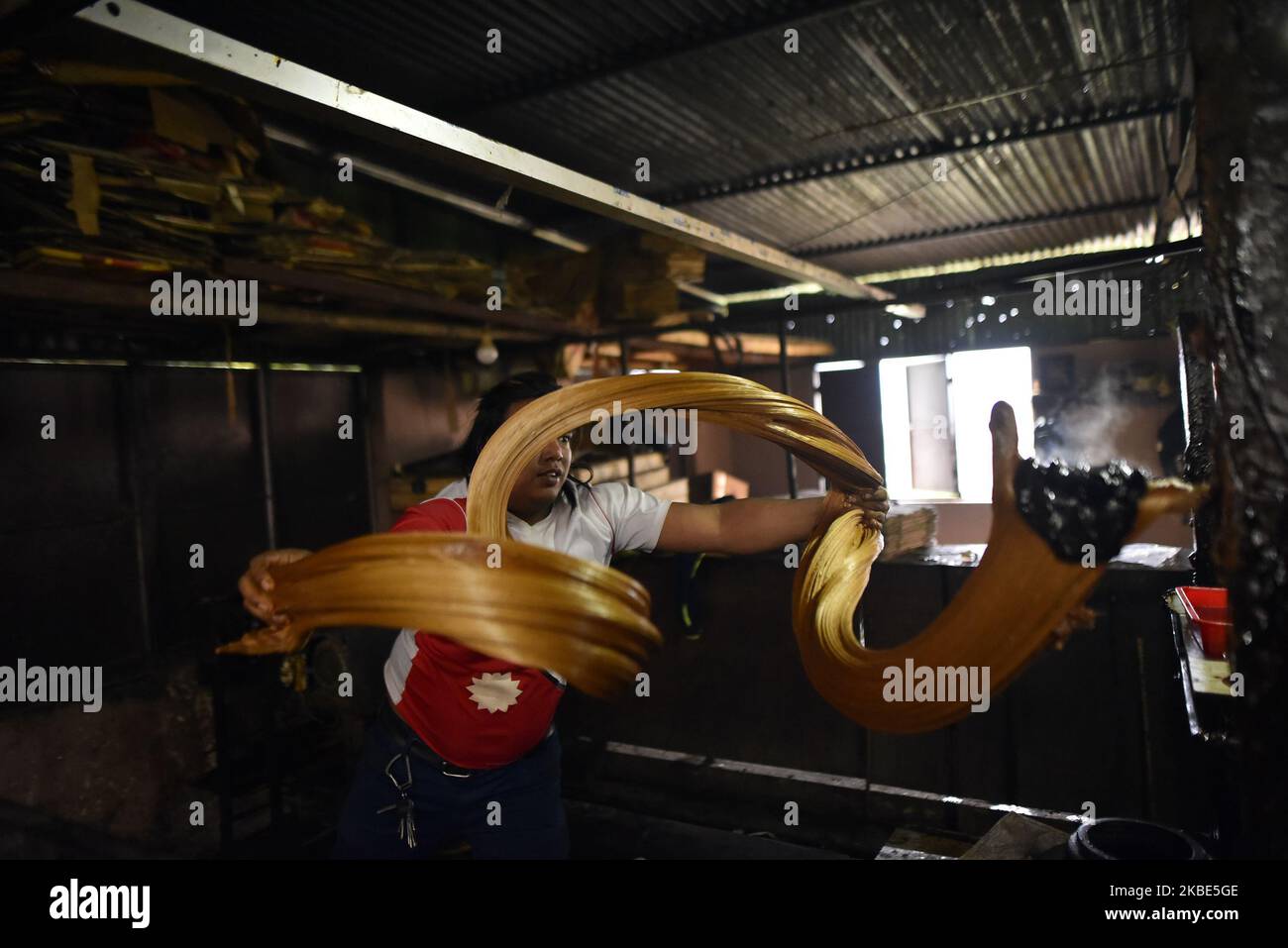 Un travailleur qui fouille des mélasses semi dures pour molasses Chaku ...