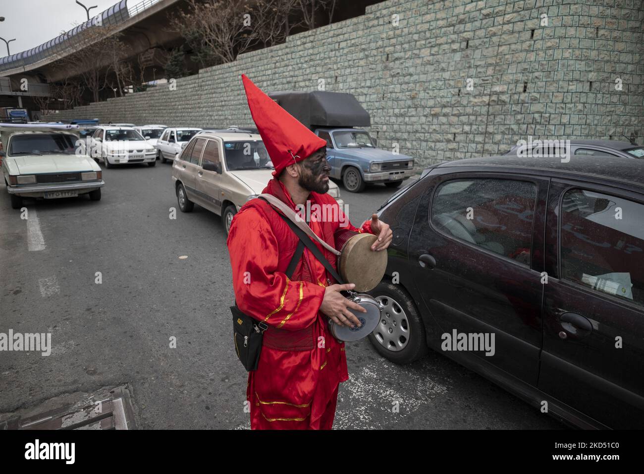 Un iranien peint son visage en noir et portait des robes rouges tandis ...