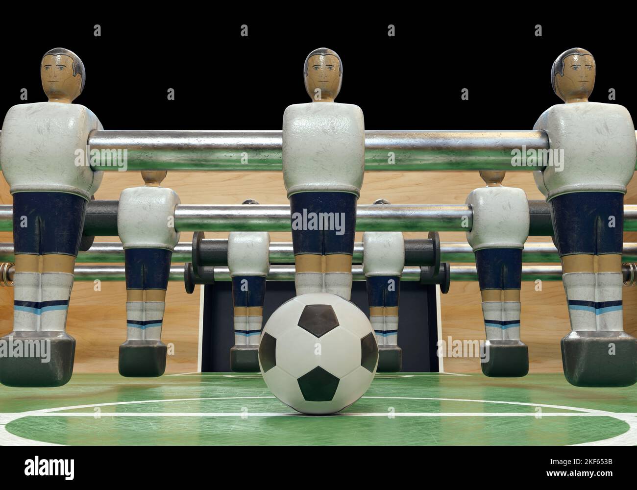 Un côté d'une table de baby-foot ou de baby-foot vintage avec des ...