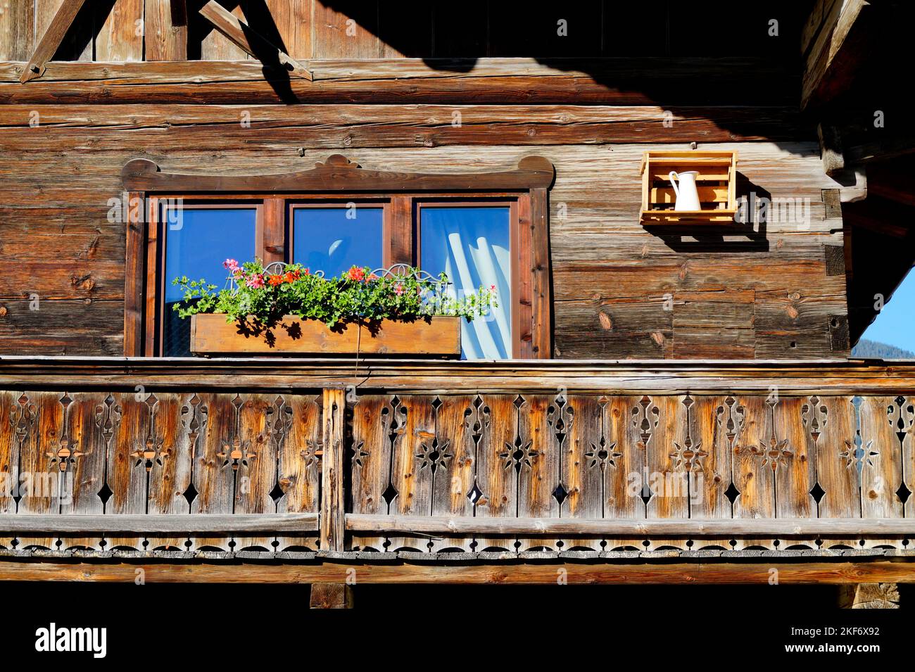 Chalet alpin rustique en bois avec géraniums sur le rebord de la ...