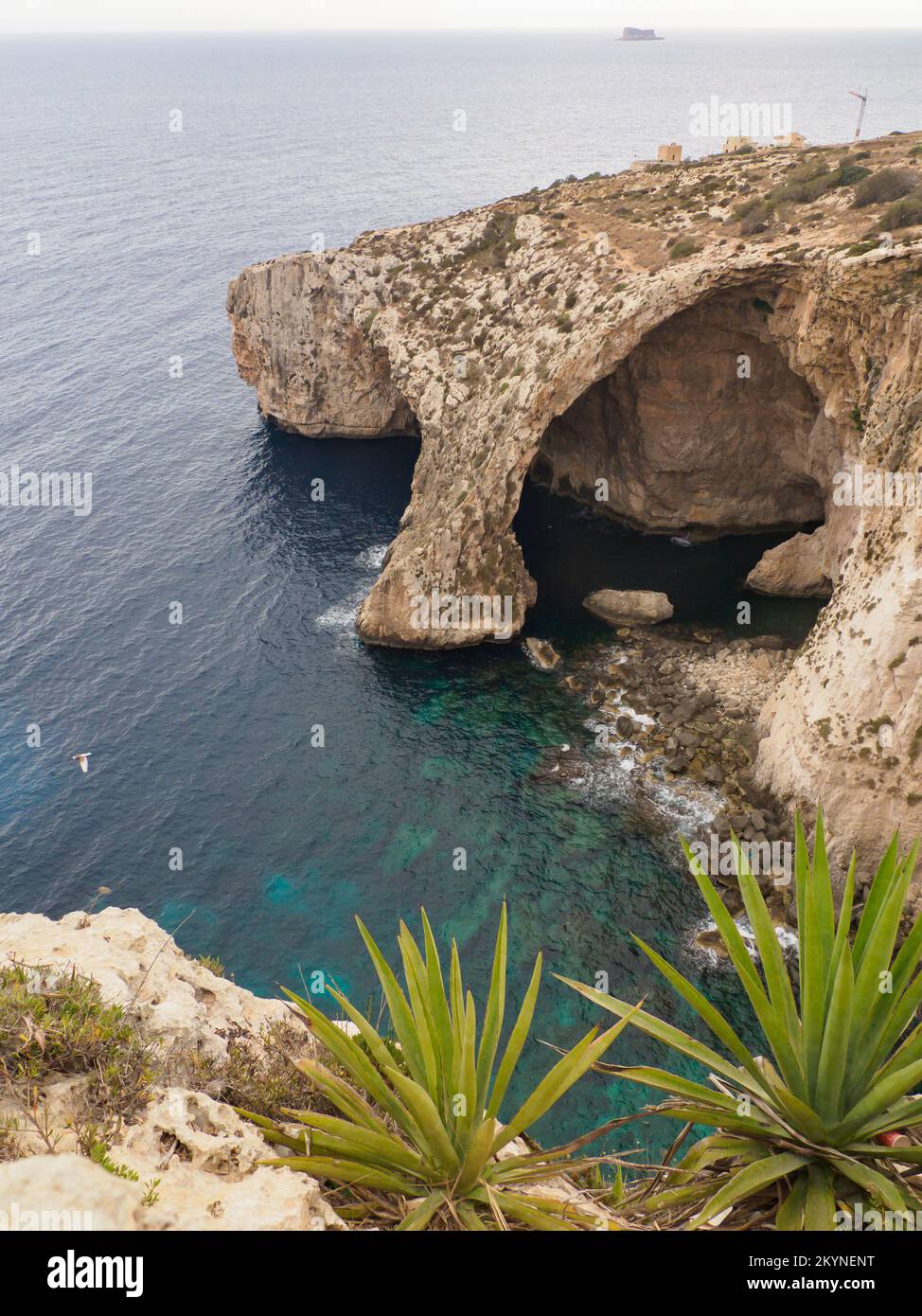 Vue sur l'eau de mer bleue et la magnifique arche de calcaire et grotte ...