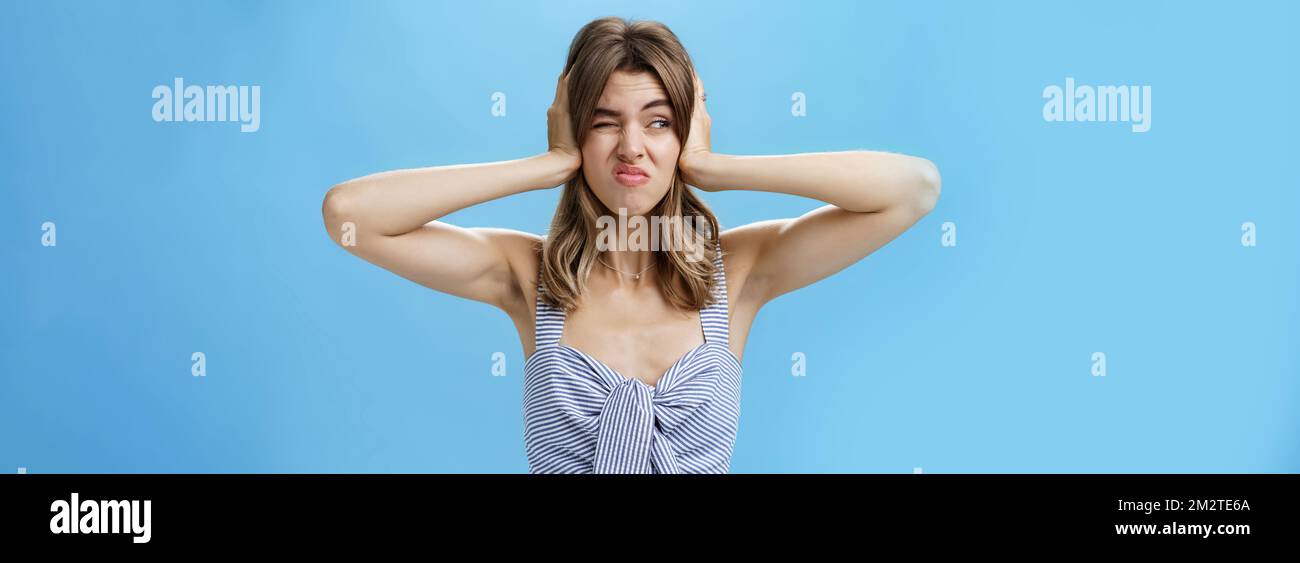 Une jeune fille se sente irritée par un bruit fort et horrible qui ...