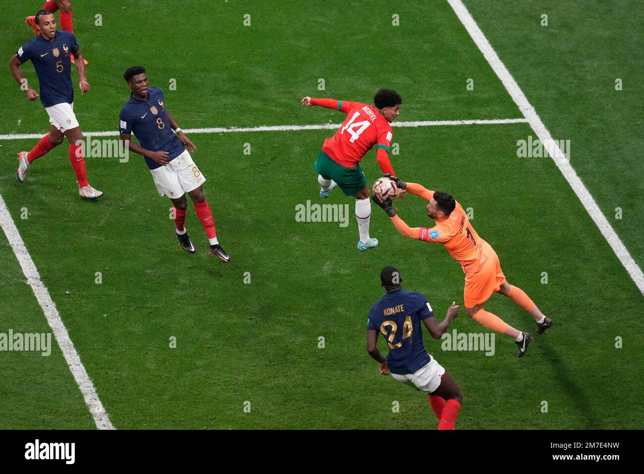 France's goalkeeper Hugo Lloris, right, grabs the ball to make a save ...