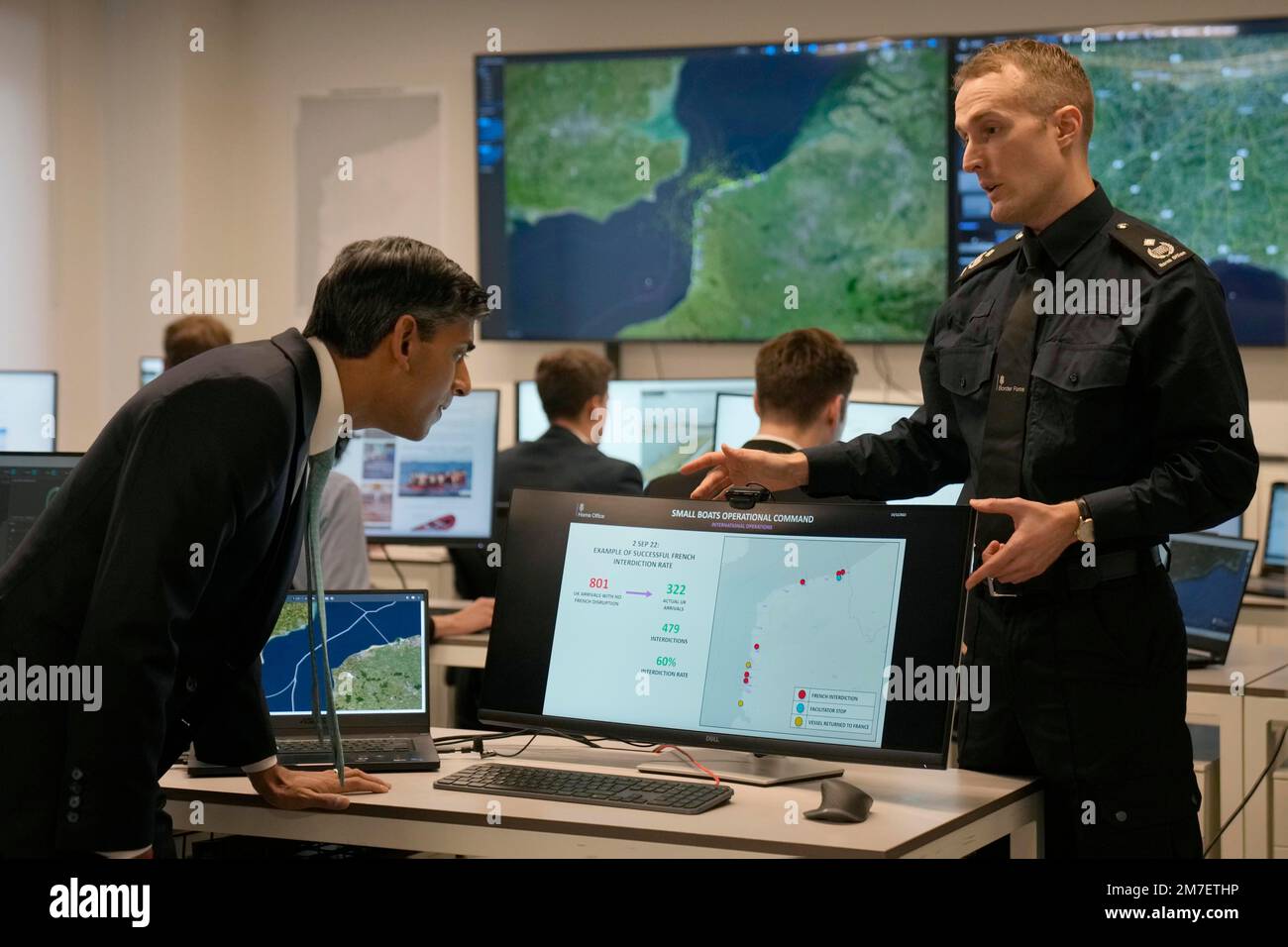 Britain's Prime Minister Rishi Sunak, left, looks at a monitor as he ...