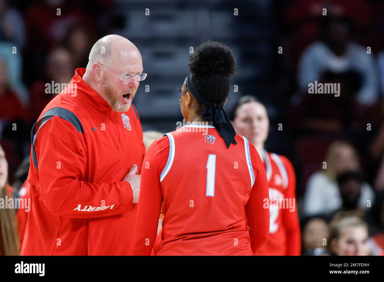 Liberty head coach Carey Green talks to guard Kennedi Williams (1 ...