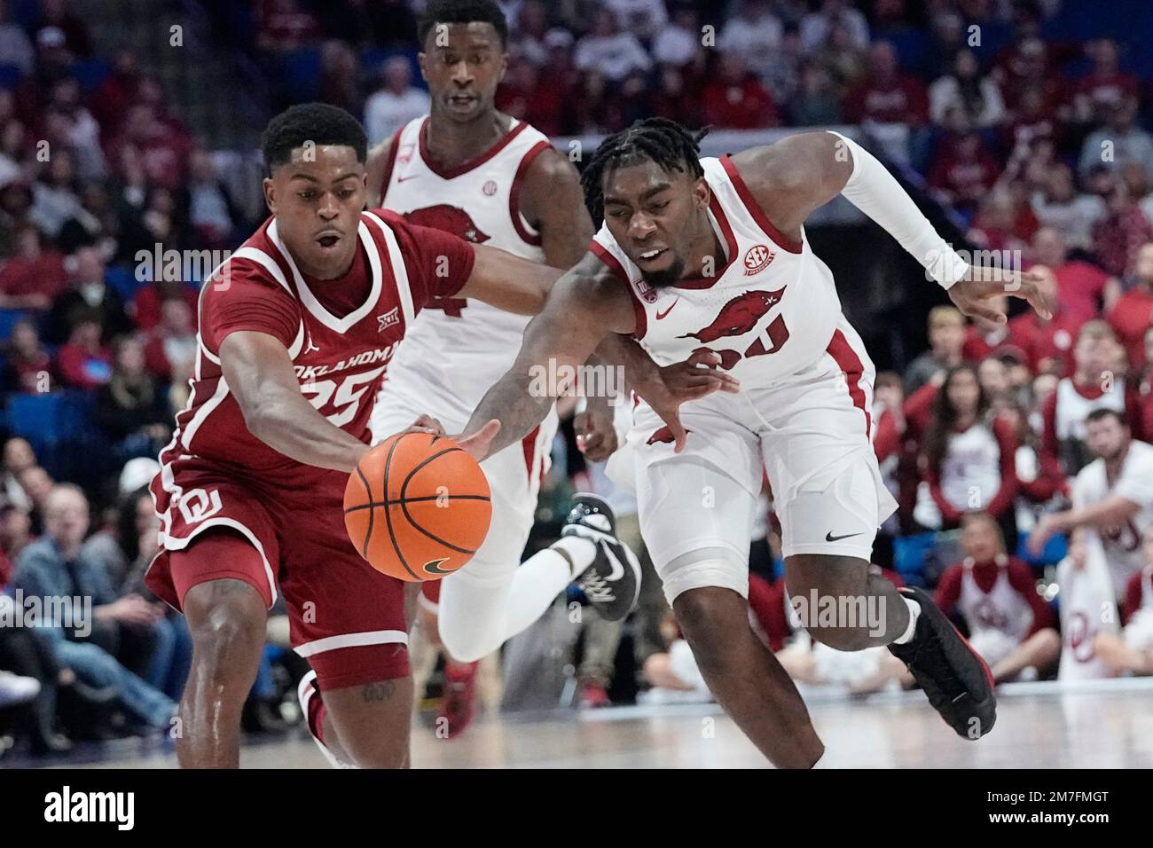 Oklahoma guard Grant Sherfield, left, and Arkansas forward Kamani ...