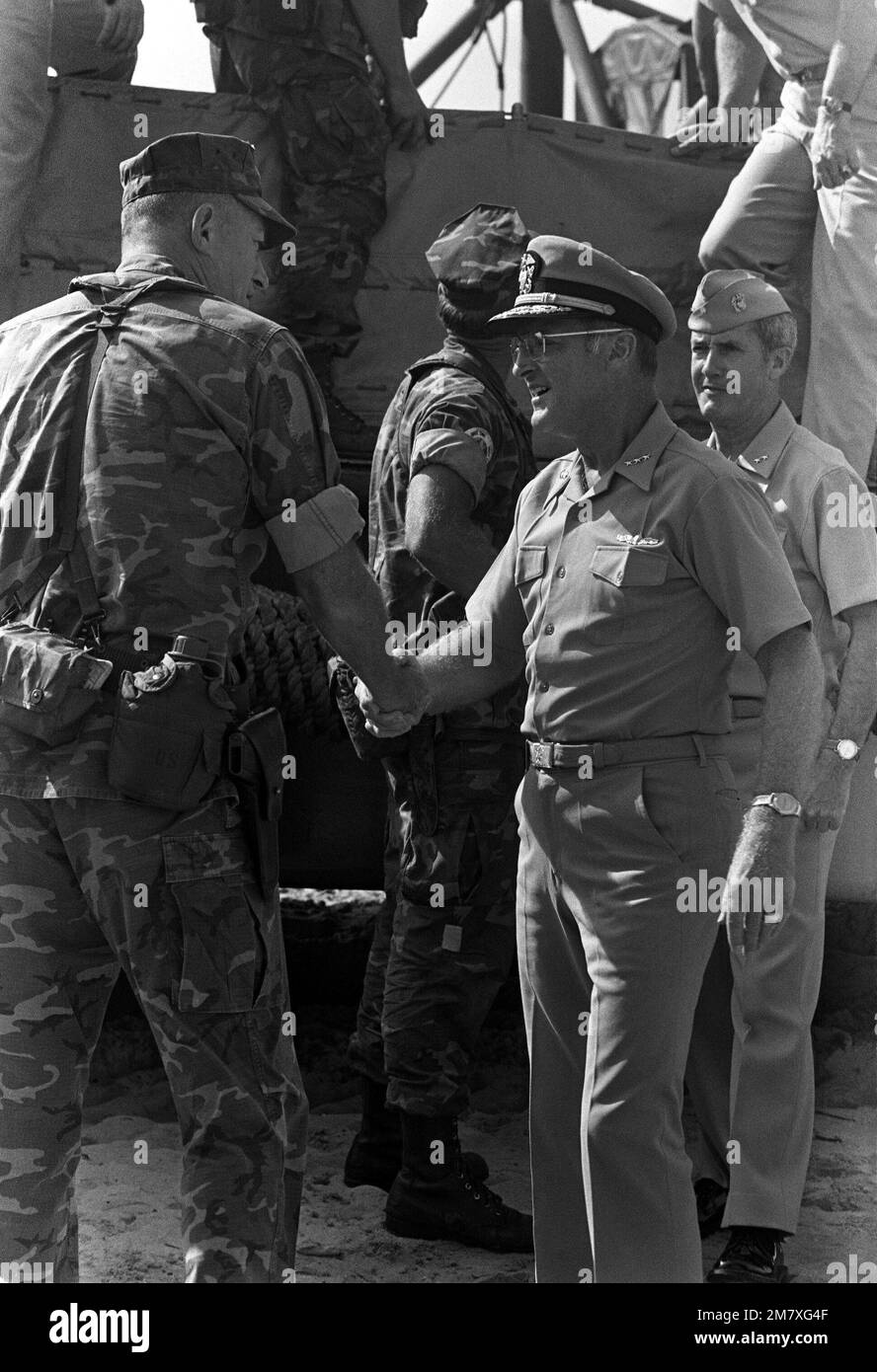 Le vice-amiral J. R. Hogg, commandant de la septième flotte, se serre ...
