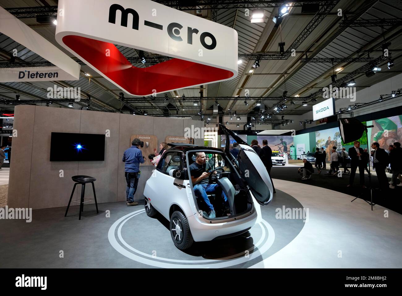A visitor tests out the cockpit of the Microlino Pioneer fully electric ...