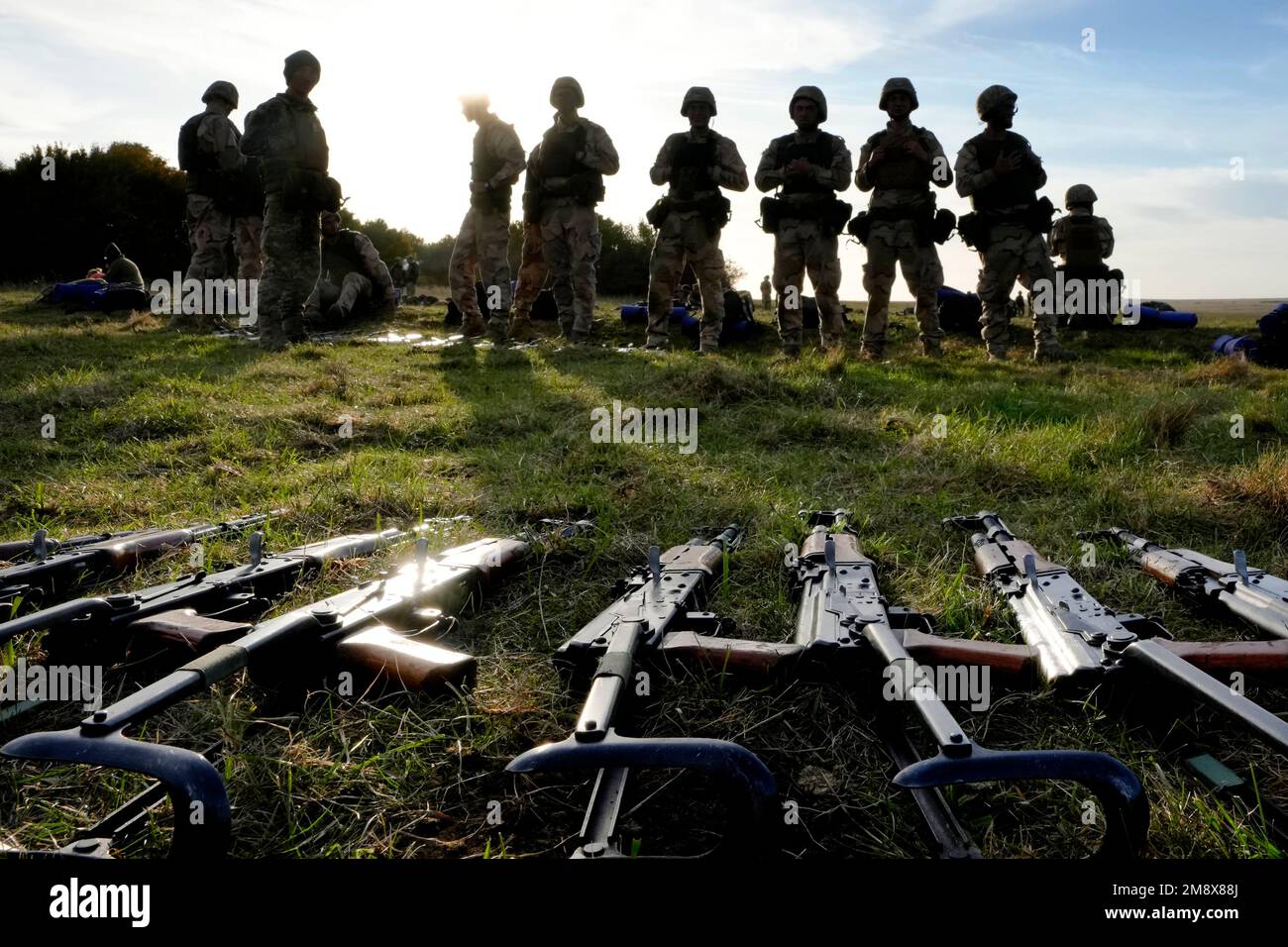 FILE - Weapons lie on the ground as Ukrainian personnel take a break ...