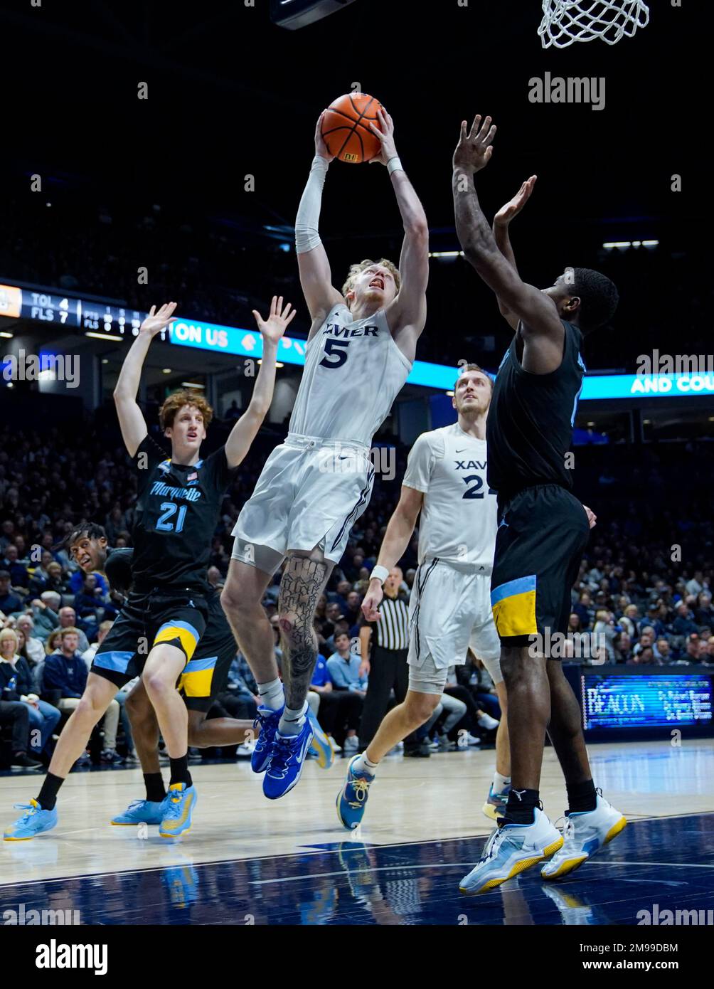 Xavier guard Adam Kunkel (5) shoots against Marquette's Kam Jones ...