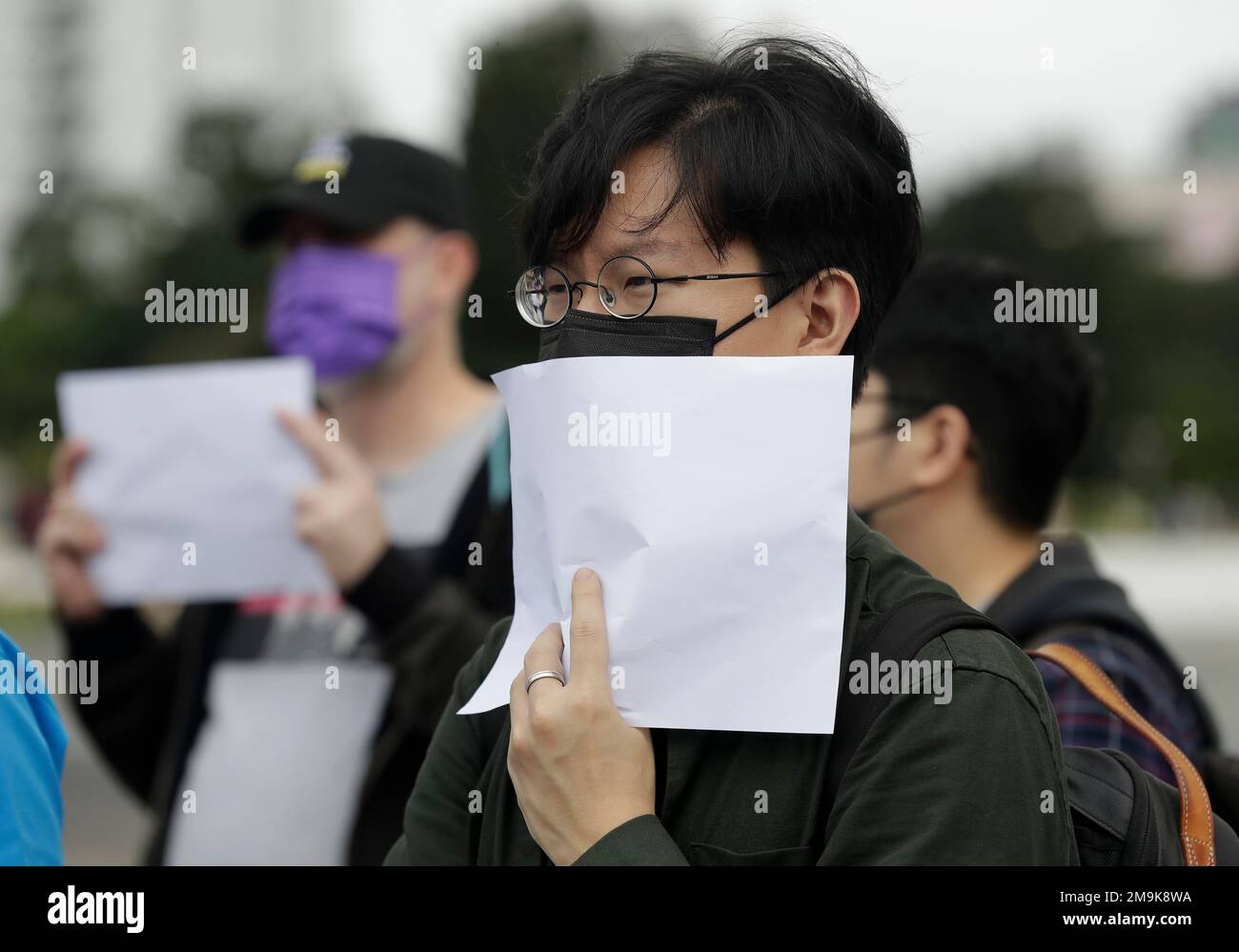 People hold A4 format paper on the Liberty Square in Taipei, Taiwan ...