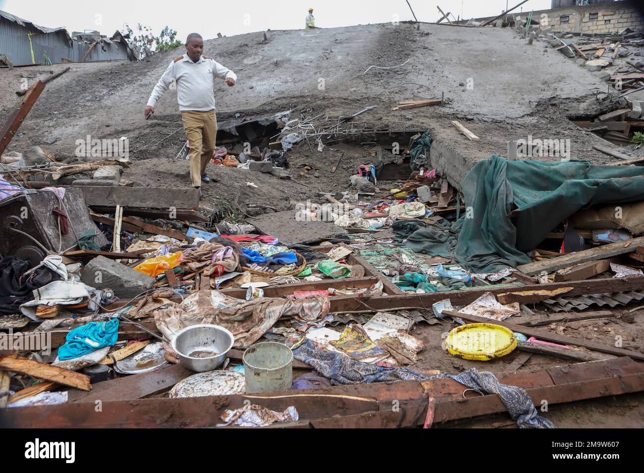 A man walks over the rubble of a building collapse in Ruaka, on the ...