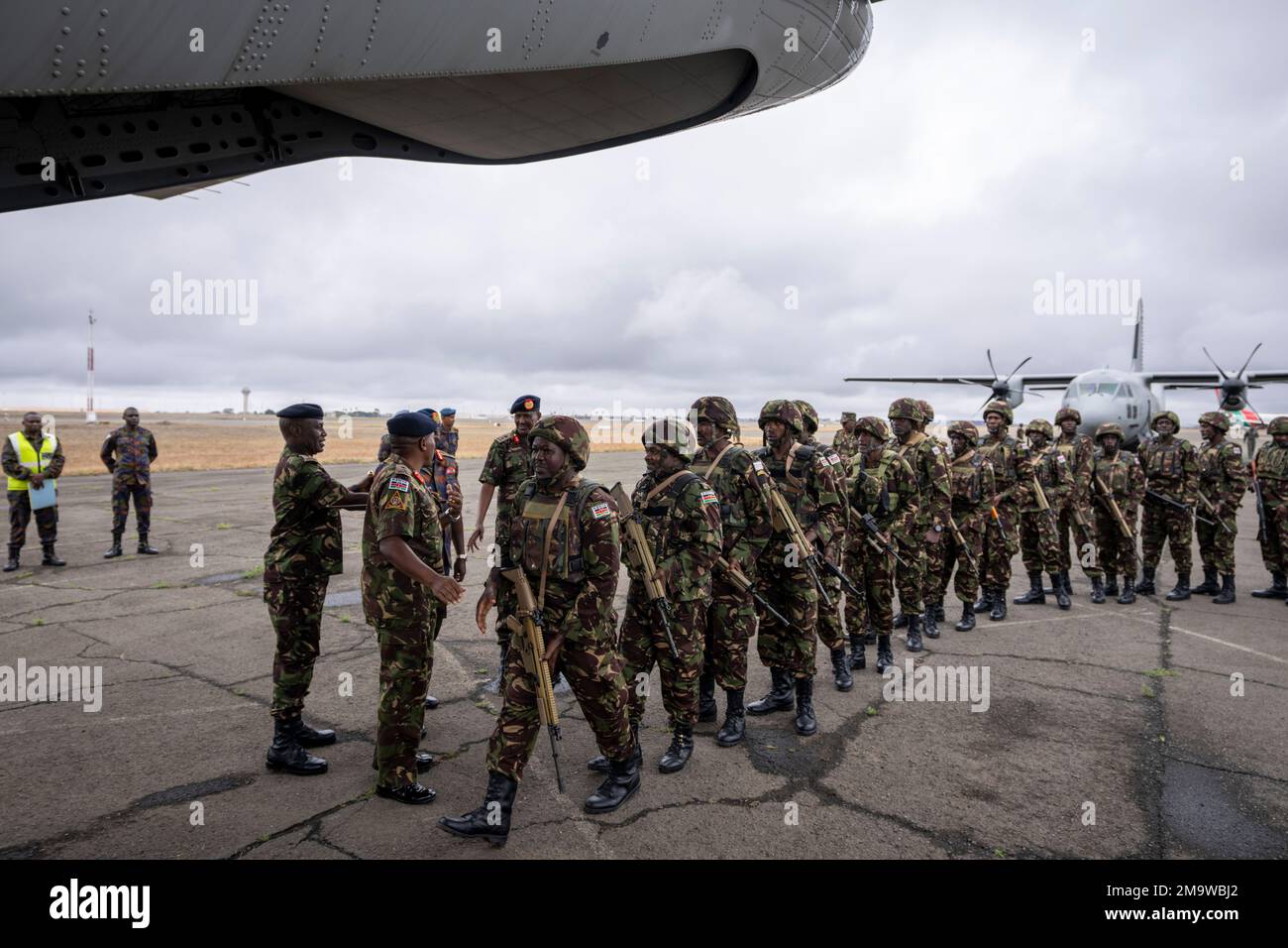 Members of the Kenya Defence Forces (KDF) line up to board transport aircraft as they deploy to ...