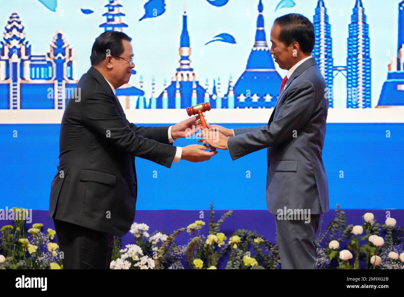 Cambodian Prime Minister Hun Sen, left, hands over the gavel to ...