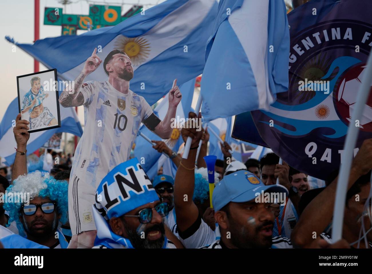 Argentinian fans hold up Argentina's player Lionel Messi pictures as ...