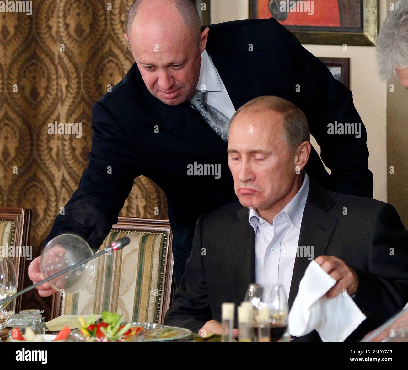 FILE - Yevgeny Prigozhin, top, serves food to then-Russian Prime ...
