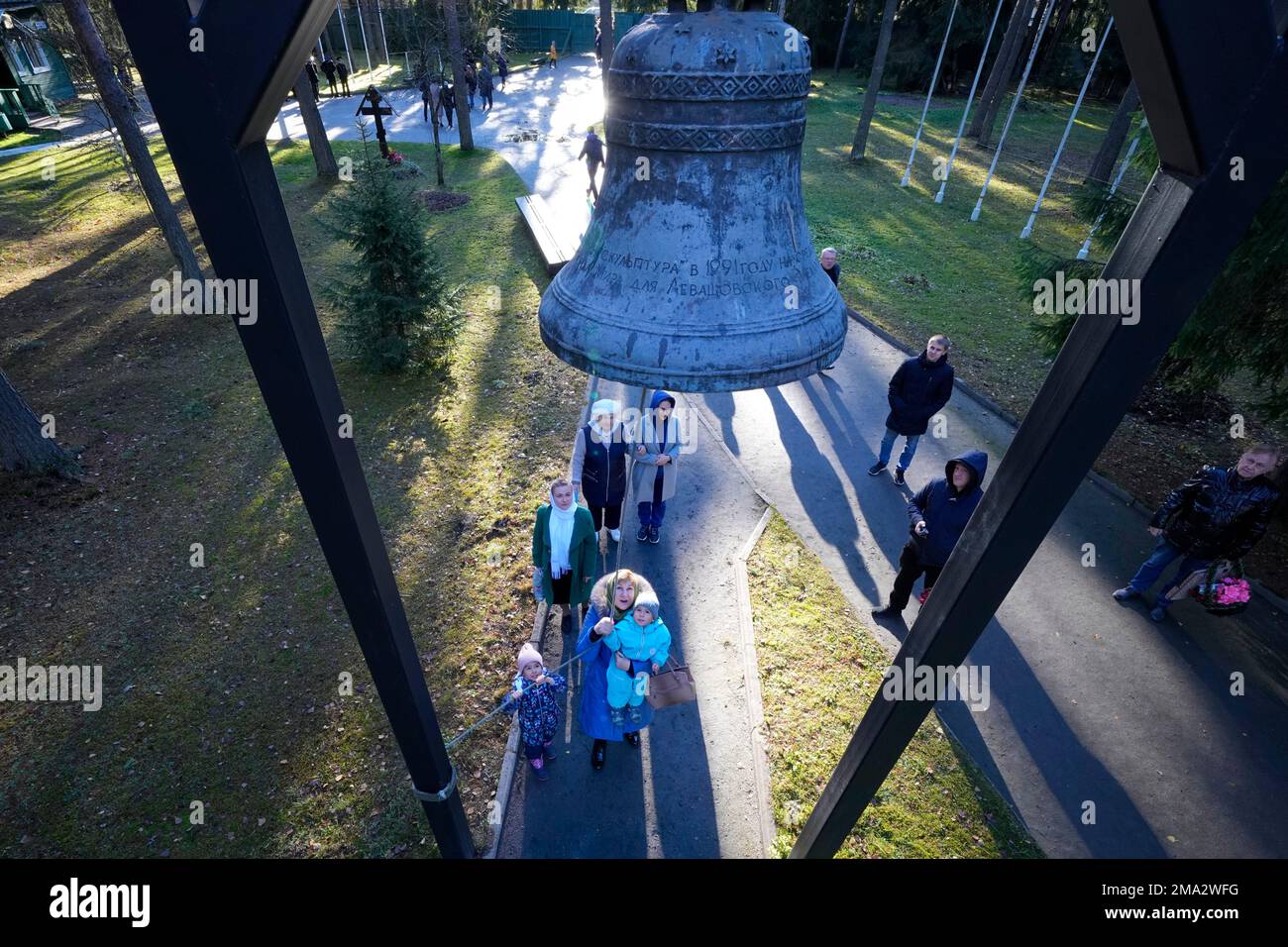 People ring the memorial bell as they gather to commemorate victims of ...