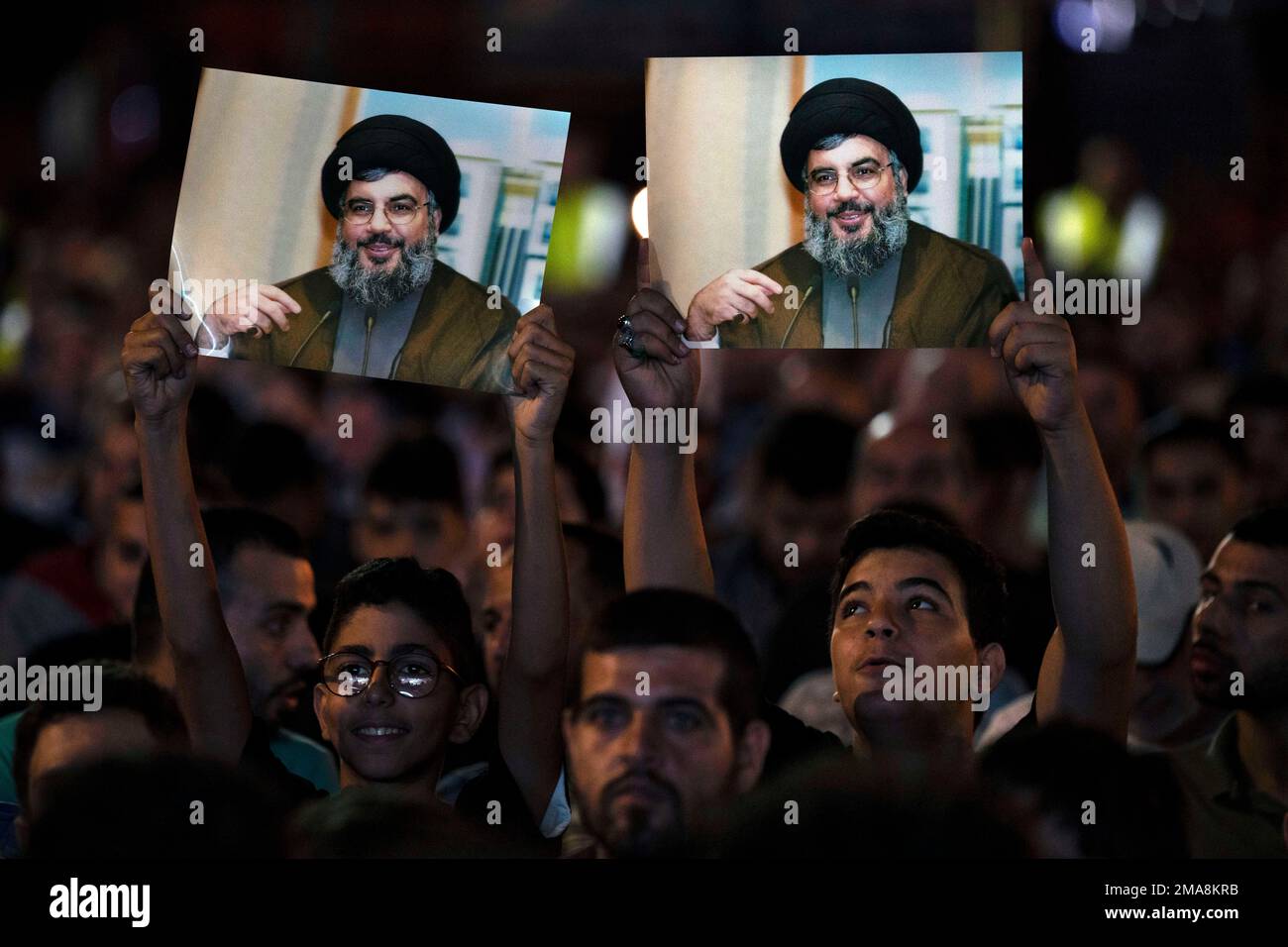 Hezbollah supporters hold up portraits of Hezbollah leader Sayyed ...