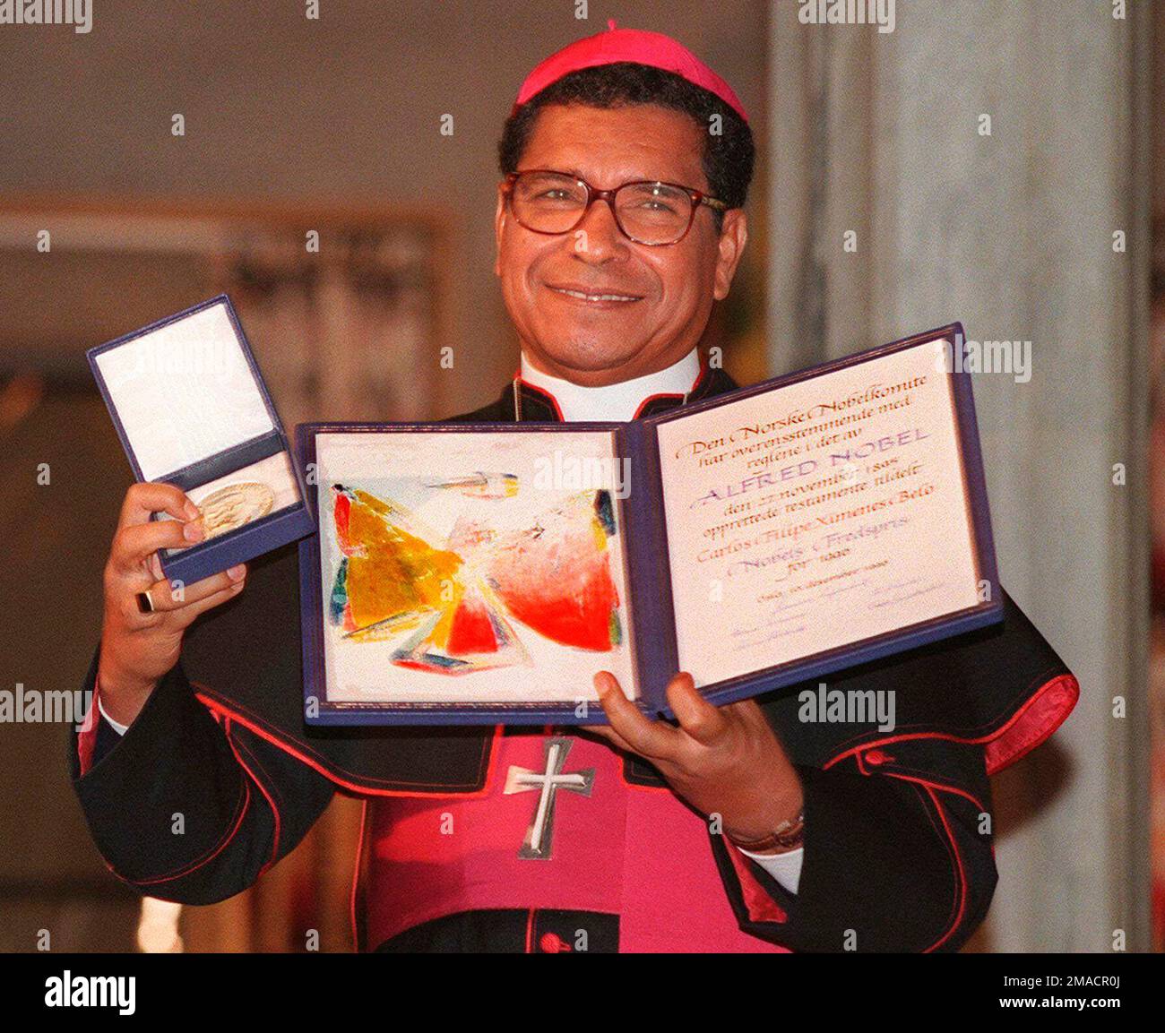 FILE - Nobel Peace Prize laureate, East Timor bishop Carlos Filipe Ximenes Belo displays his ...
