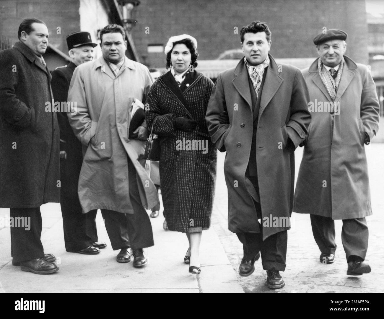 Pierre Poujade and his wife Yvette Seva, center, walk with an ...