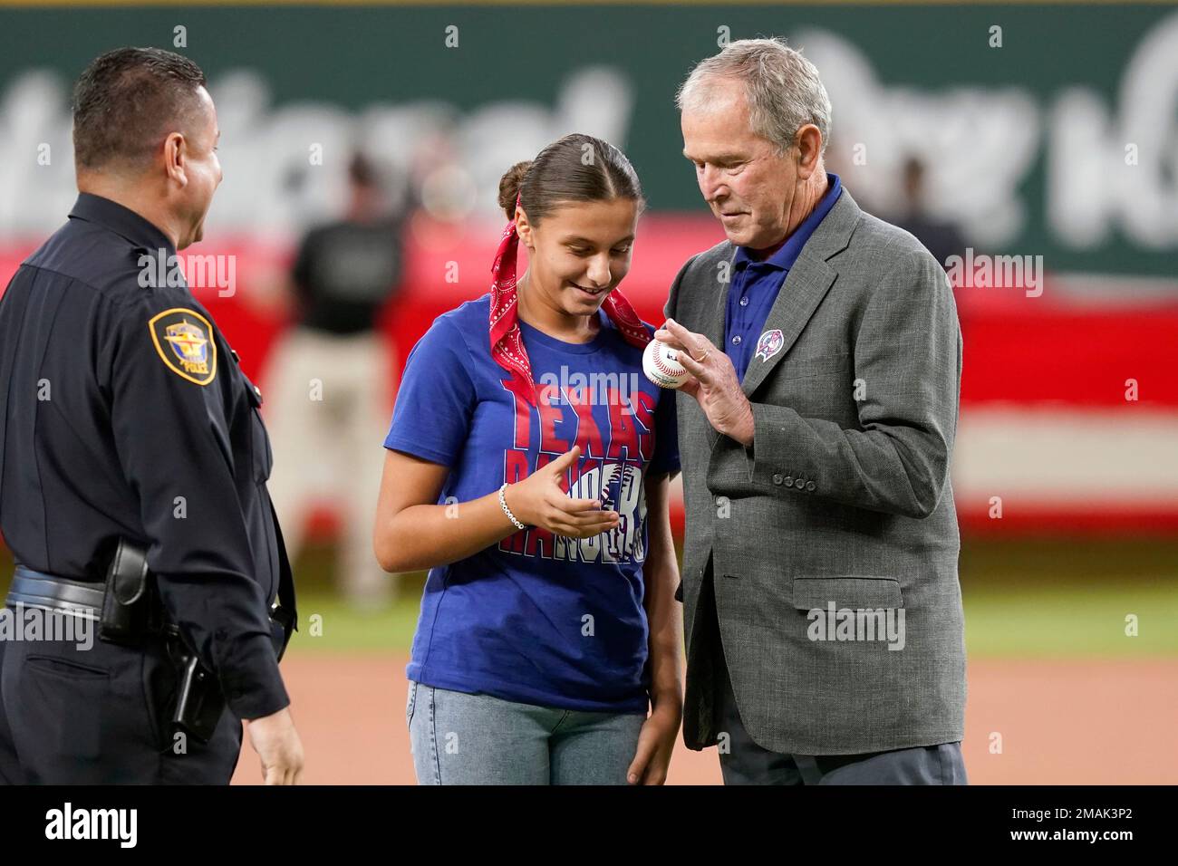 Former President George W. Bush, right, hands the ball to Andita ...