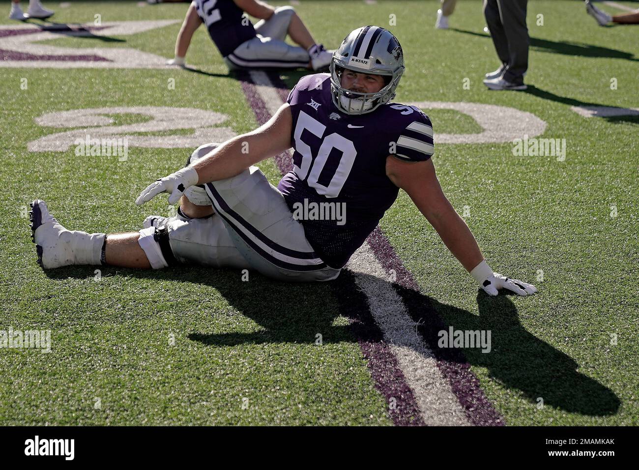 Kansas State offensive lineman Cooper Beebe stretches before an NCAA ...