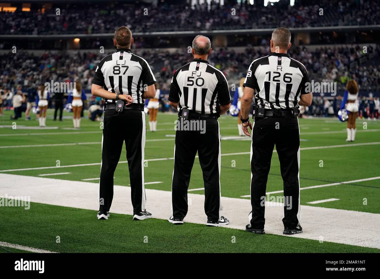 Line judge Tom Eaton (87), field judge Aaron Santi (50) and referee ...