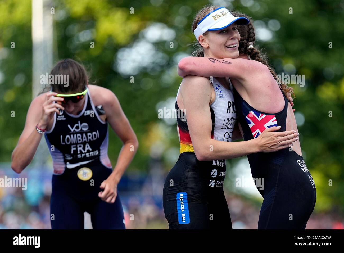 Third placed Emma Lombardi of France, left, crosses the finish line as ...