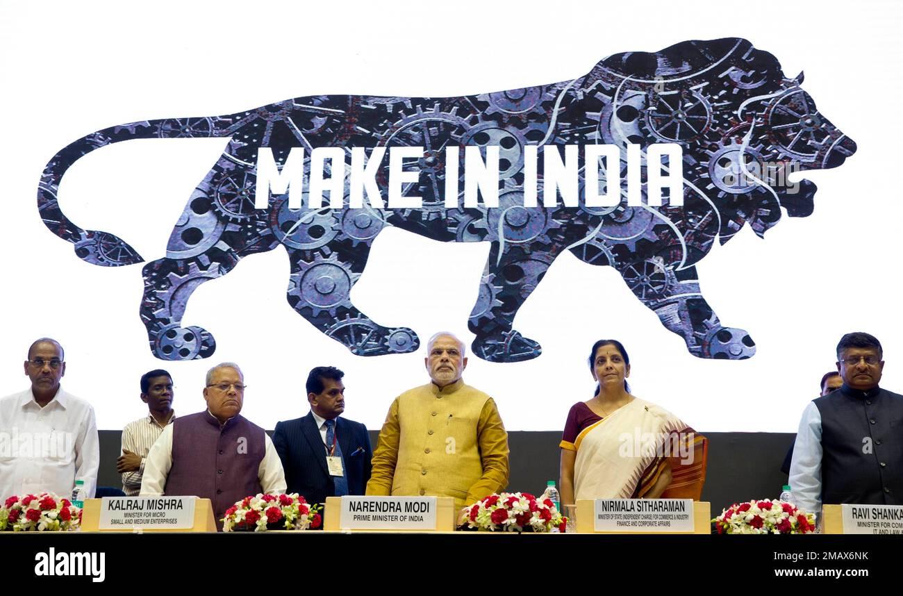 FILE - Indian Prime Minister Narendra Modi, center, unveils the logo of ...