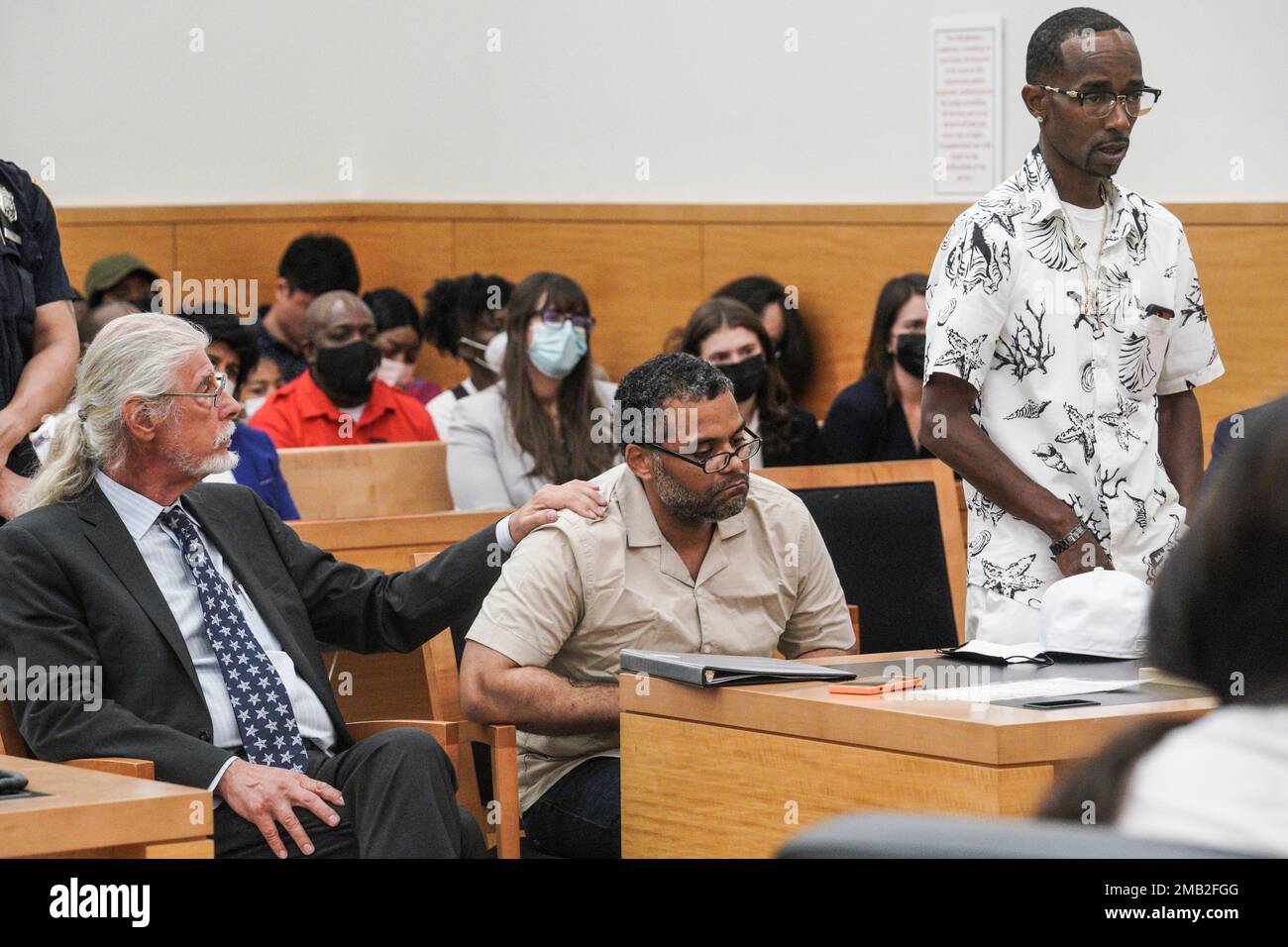 Attorney Ron Kuby, left, comforts Thomas Malik, center, as Vincent ...