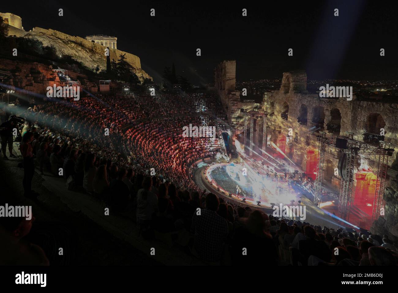 The ancient Parthenon temple is illuminated in the background of the ...