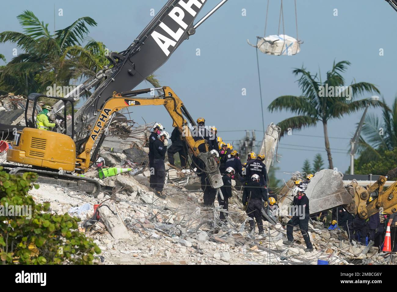 FILE - Rescue crews work at the site of the collapsed Champlain Towers ...