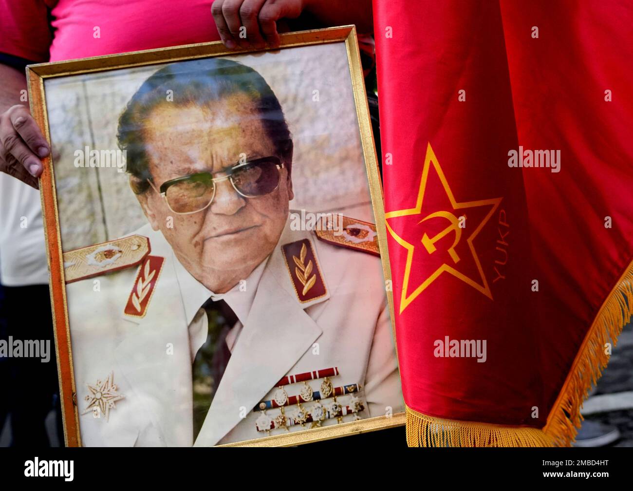 A man holds picture of the late Yugoslav communist president Josip Broz ...
