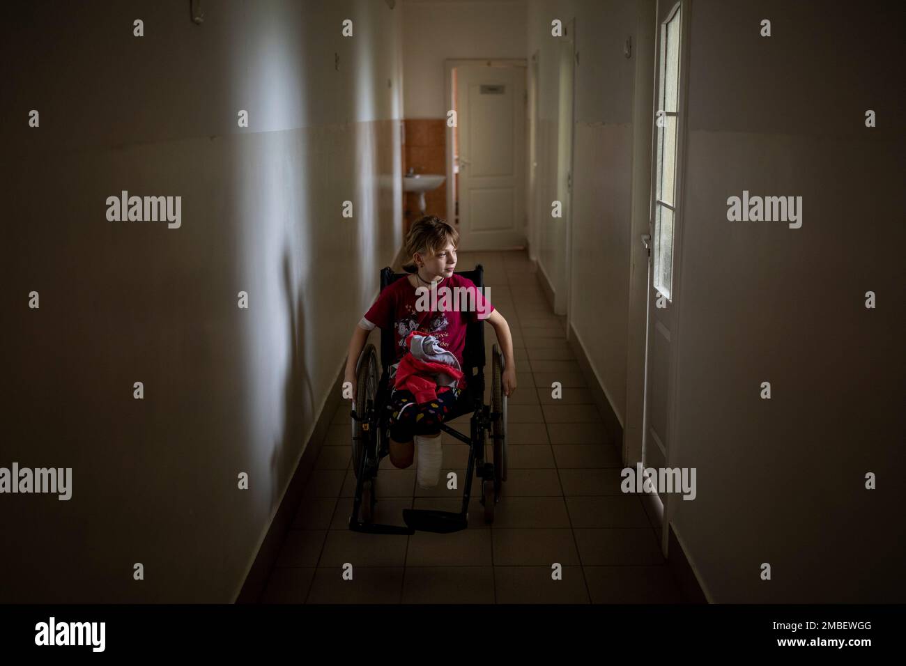 Yana Stepanenko, 11, sits next to the window on her wheelchair at a ...