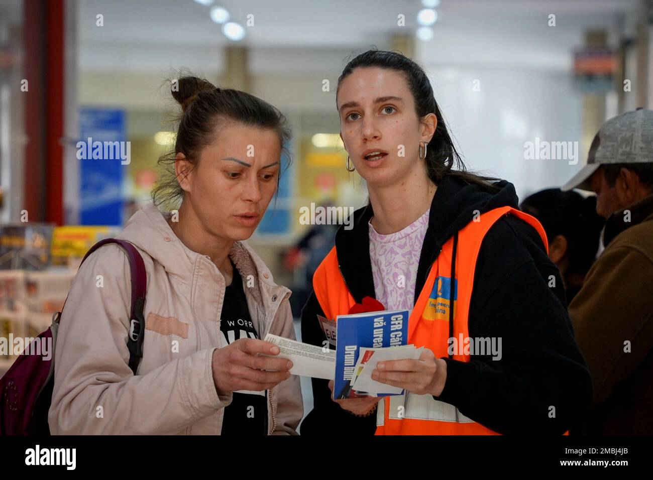 Elena Trofimchuk, who fled the southern Ukrainian city of Odesa, helps ...