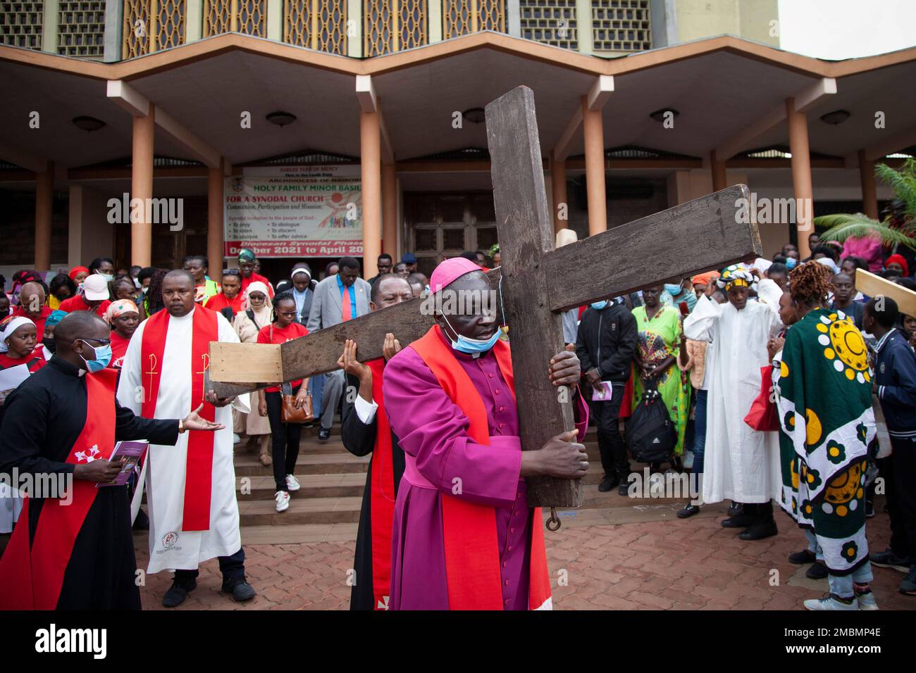 Archbishop of Nairobi Philip Anyolo, center, carries a wooden cross as ...