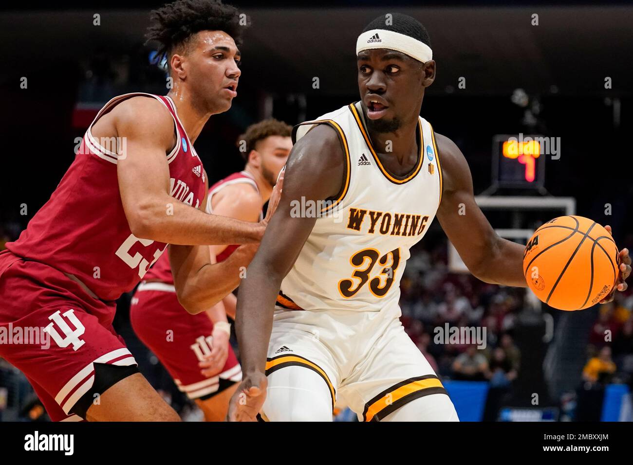 Wyoming forward Graham Ike (33) drives past Indiana's Trayce Jackson ...