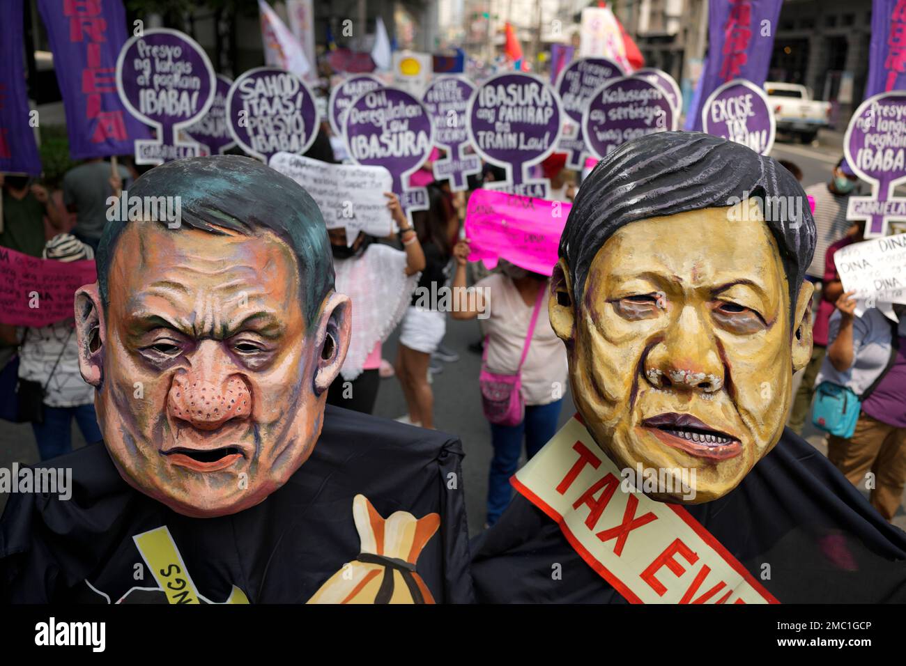 Protesters wear masks portraying Philippine President Rodrigo Duterte ...