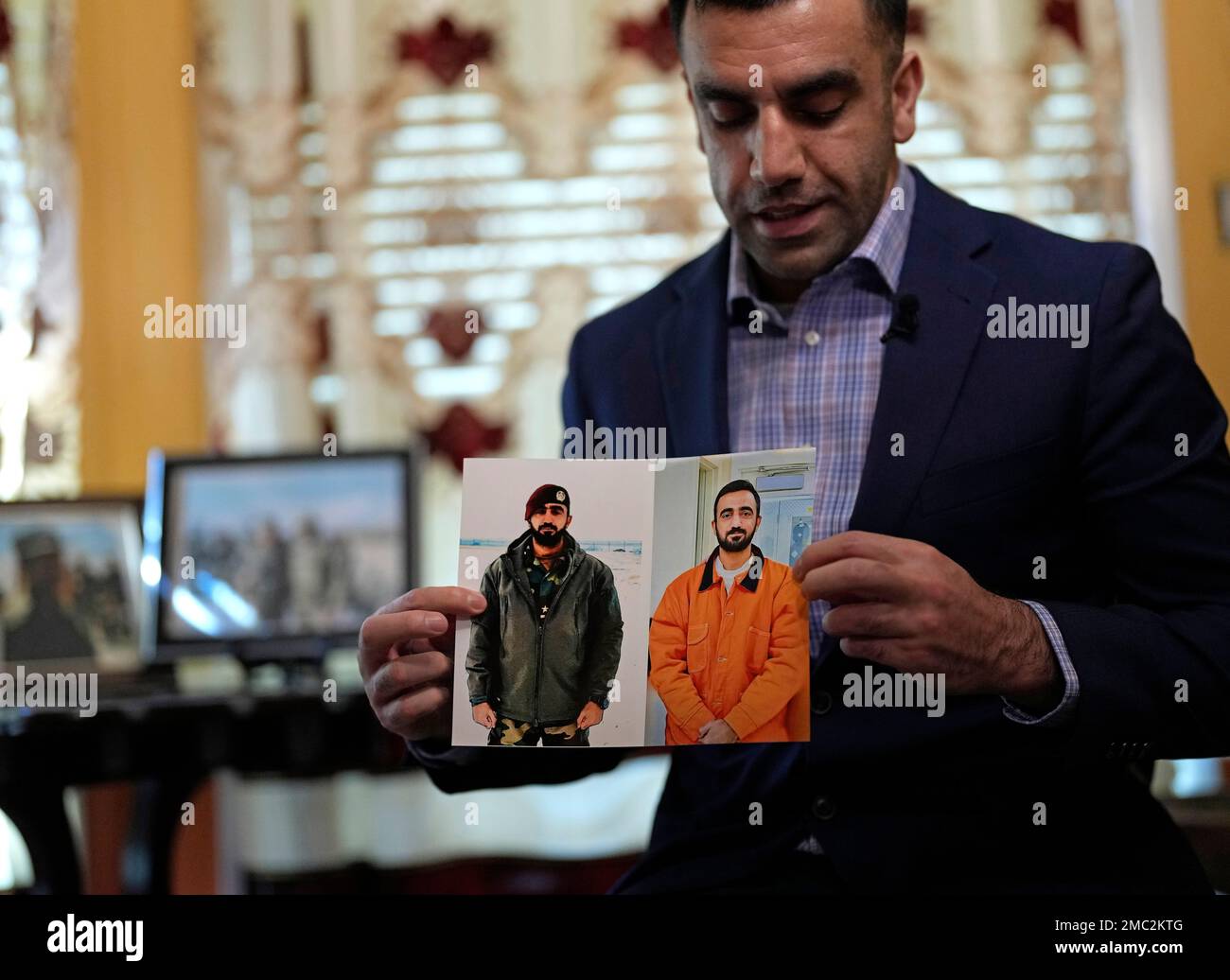 Sami-ullah Safi holds photographs of his brother, Abdul Wasi Safi, as ...